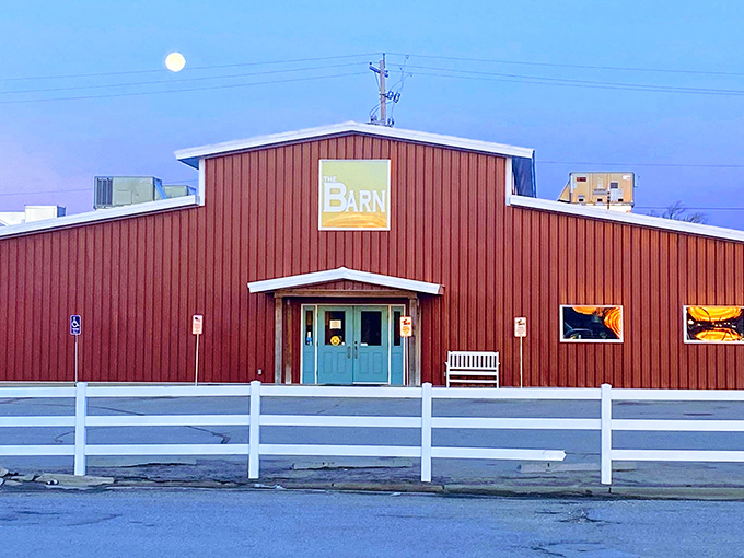 The bright red exterior of The Barn stands out against the Kansas sky like a beacon for hungry travelers. No fancy frills, just the promise of honest-to-goodness comfort food inside.