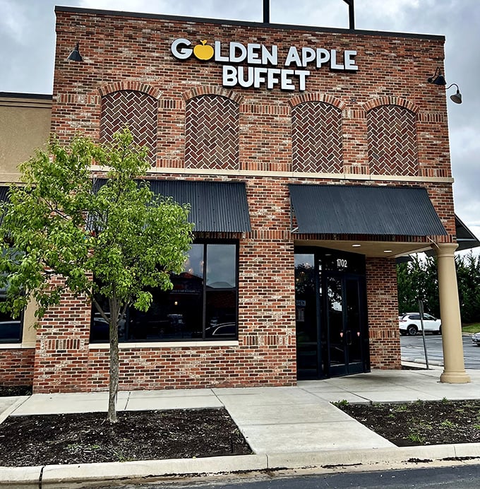 The brick facade of Golden Apple Buffet stands like a temple to abundance, promising culinary adventures behind those metal-awninged windows.