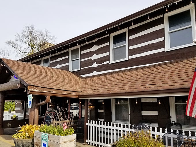 The iconic Log Cabin Inn exterior showcases authentic cabin architecture with its distinctive brown and white pattern&mdash;Kentucky comfort food headquarters in architectural form. 