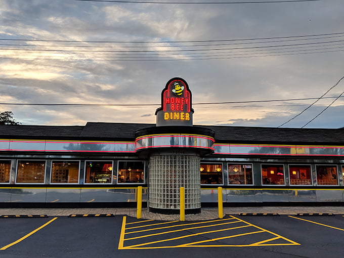 The cheerful cartoon bee sign beckons hungry travelers like a lighthouse for the famished. Even on rainy days, this Glen Burnie landmark promises comfort inside.