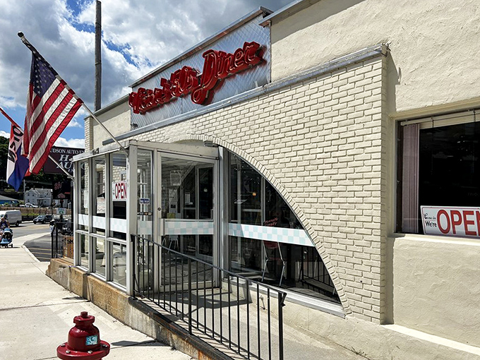 The classic white brick exterior of Victor's 50's Diner stands like a time capsule in Hudson, complete with that iconic red neon sign beckoning hungry travelers.
