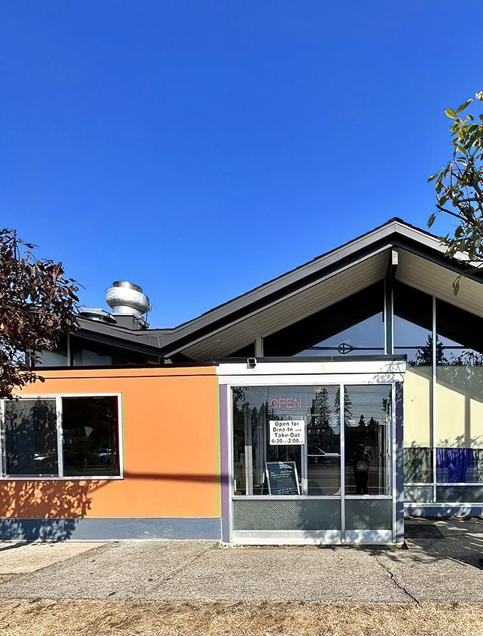 The iconic blue and white arrow sign stands like a beacon of breakfast hope against Portland's famously fickle sky. Classic Americana at its finest.