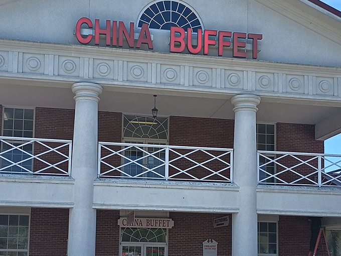 The stately white columns of China Buffet stand proudly against the blue sky, like a temple dedicated to the worship of all-you-can-eat delights.