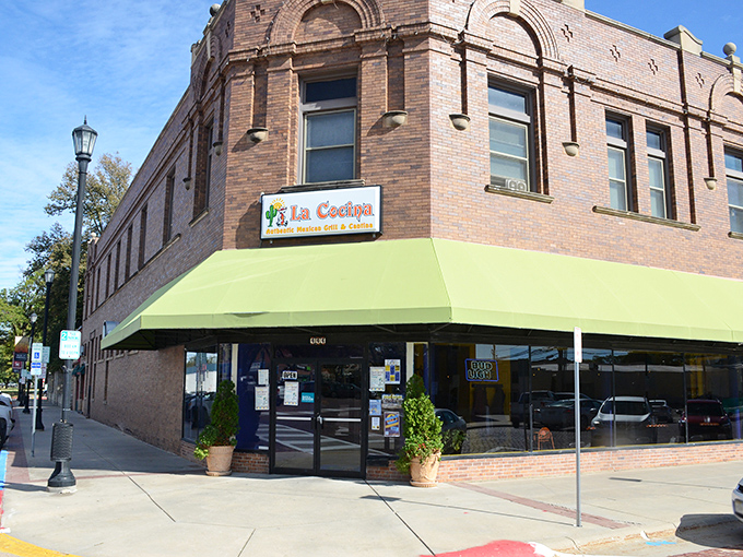 La Cocina's unassuming brick exterior with its cheerful green awning stands as Seward's culinary beacon, promising Mexican treasures within.