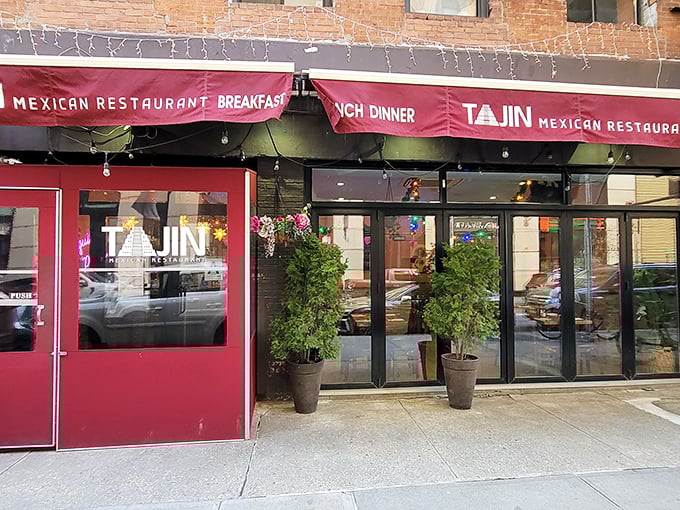 The crimson awning of Tajin beckons like a culinary lighthouse in the urban sea, promising authentic Mexican flavors behind those welcoming doors.
