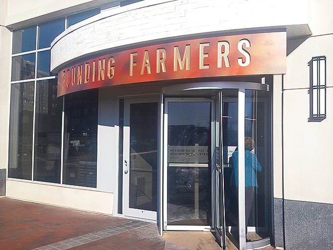 The unassuming entrance to flavor paradise. Founding Farmers' modest exterior in Potomac gives zero hints about the culinary fireworks waiting inside.