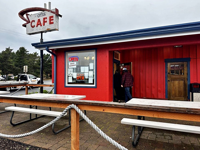 The iconic red exterior of Otis Caf&eacute; stands like a beacon for hungry travelers on Highway 18, promising comfort food salvation just minutes from the Oregon coast. 