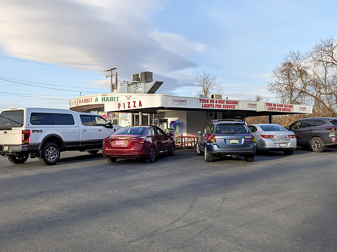 The iconic "Make The Red Rabbit A Habit" sign welcomes hungry travelers like a beacon of burger salvation on Route 322. Nostalgia never tasted so good.