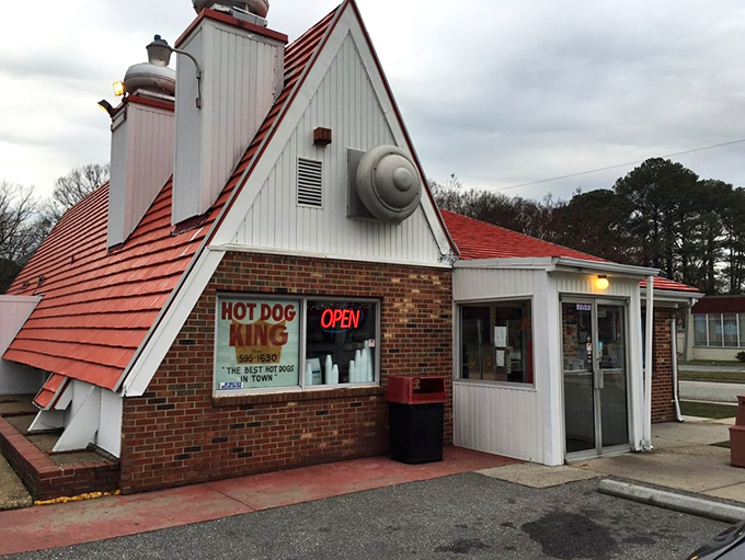 A classic red-roofed building welcomes you to enjoy a quick bite and the best hot dogs in this friendly neighborhood.