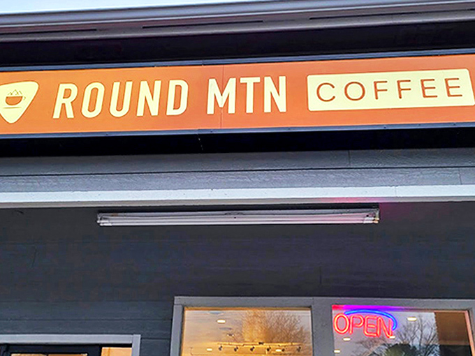 That distinctive orange sign beckons like a lighthouse for the caffeine-deprived, promising salvation in a cup just beyond those welcoming doors.