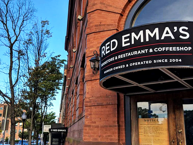 The iconic red brick exterior of Red Emma's stands as Baltimore's literary lighthouse, beckoning bibliophiles and coffee enthusiasts alike since 2004.