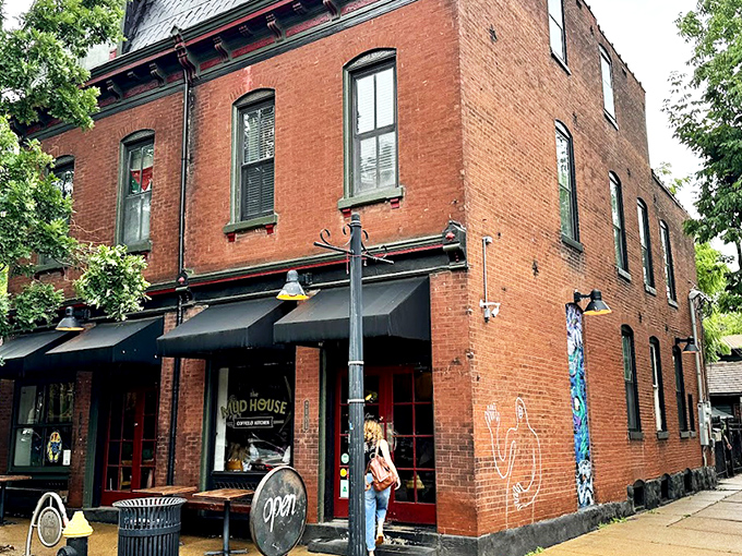 The corner brick building stands like a caffeinated sentinel on Cherokee Street, its classic St. Louis architecture promising refuge for coffee pilgrims.