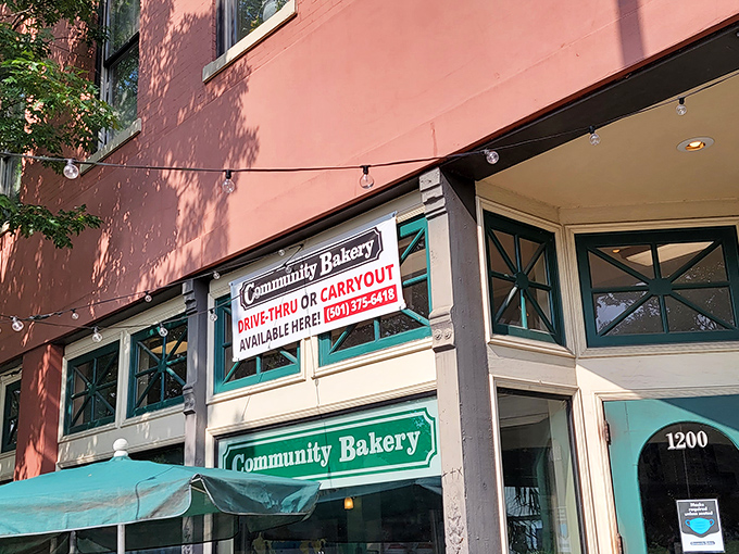 The iconic teal-trimmed entrance of Community Bakery beckons like an old friend, promising delicious treasures within its historic downtown walls.