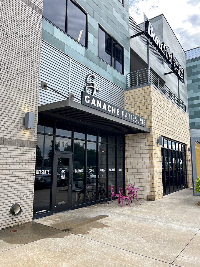 The sleek exterior of Ganache Patisserie promises Parisian delights in Oklahoma City. That blue umbrella beckons like a culinary oasis in the urban landscape.