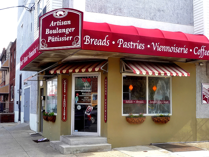 The charming exterior of Artisan Boulanger Patissier beckons from its South Philly corner, promising French delights behind that unassuming burgundy awning. 
