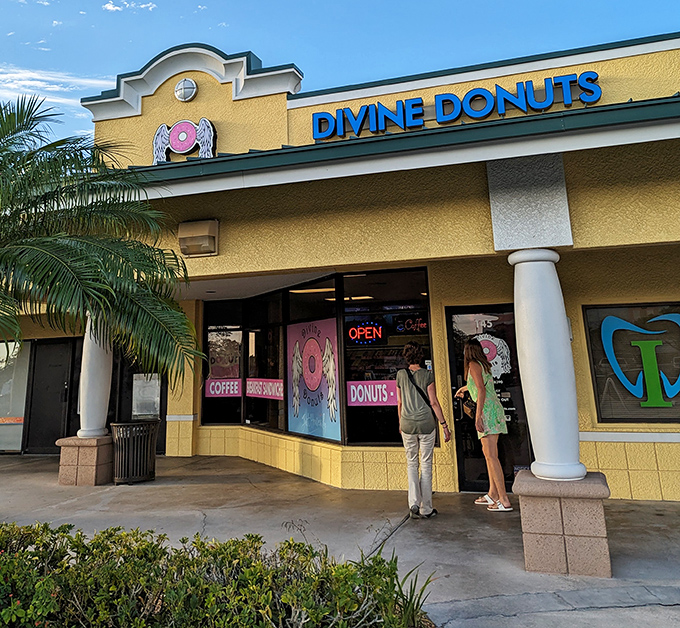 The sunshine-yellow exterior of Divine Donuts stands out like a beacon of hope for the sugar-deprived, complete with their angelic donut logo promising heavenly treats inside.