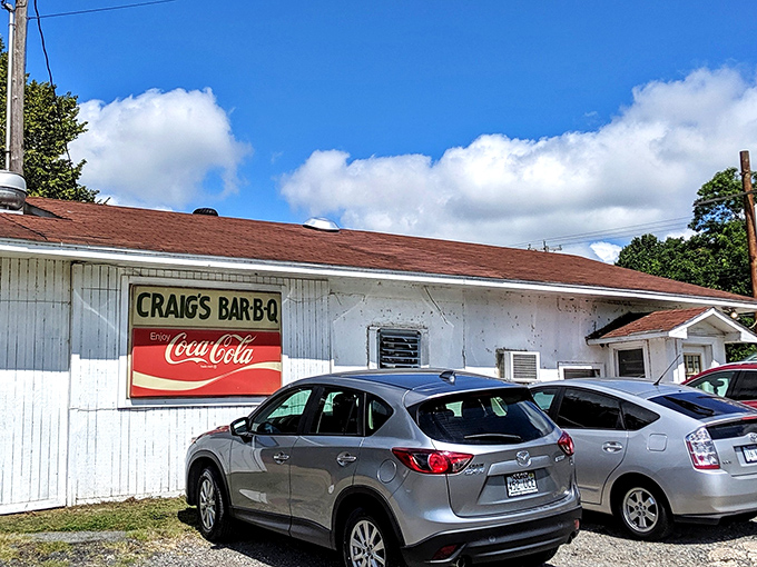 The unassuming white building with its vintage sign promises more than meets the eye. Barbecue pilgrims know: the humbler the exterior, the better the meat inside.