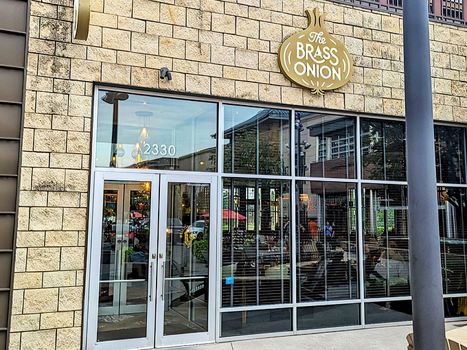 The Brass Onion's inviting exterior glows at twilight, with a cozy fire feature that practically whispers, "Come in and stay awhile."
