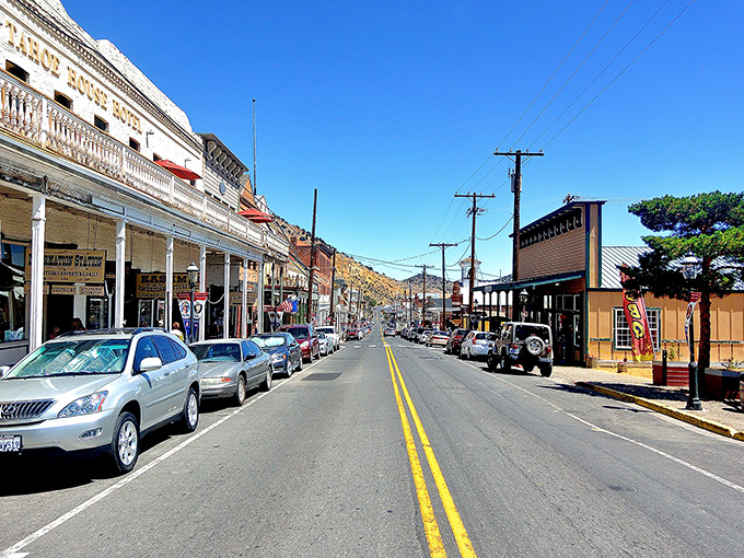 C Street stretches before you like a living museum, where Victorian-era buildings stand shoulder to shoulder under Nevada's impossibly blue sky.
