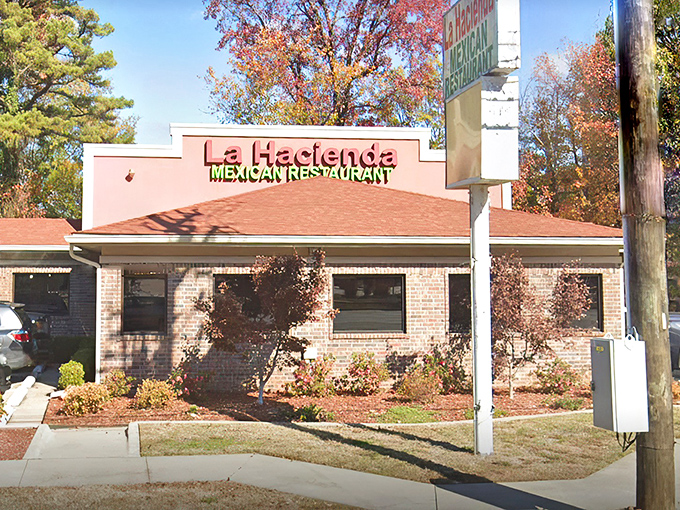 
The unassuming salmon-colored exterior of La Hacienda stands like a culinary lighthouse amid autumn foliage, promising authentic Mexican treasures within.