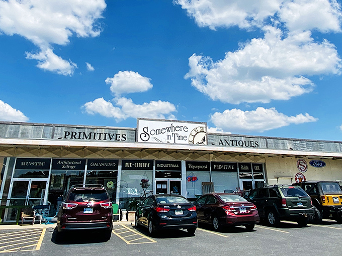 The unassuming storefront of Somewhere In Time beckons with promises of "PRIMITIVES" and "ANTIQUES" &ndash; a time portal disguised as a strip mall tenant.