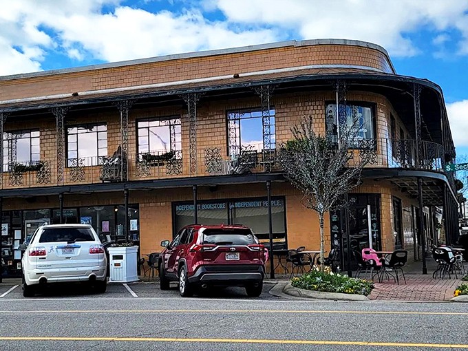 The iconic brick exterior of Page & Palette stands like a literary lighthouse on Fairhope's corner, beckoning bookworms with its New Orleans-inspired balconies.