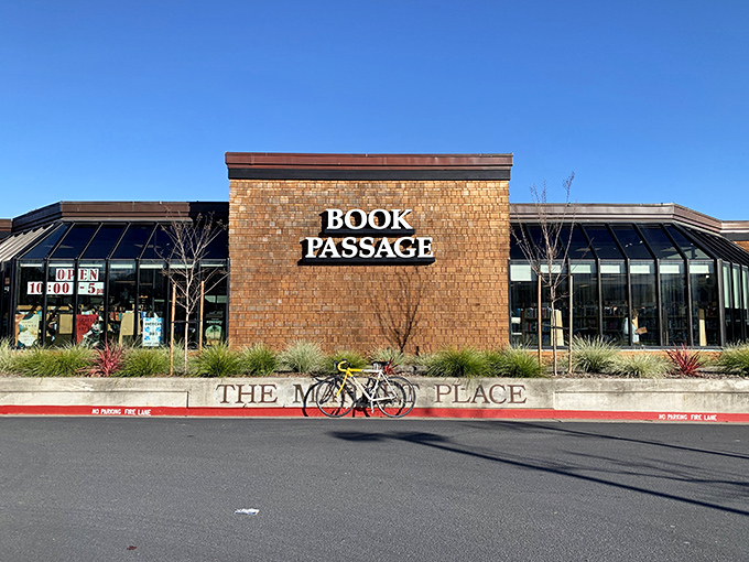 The brick facade of Book Passage beckons like a literary lighthouse, promising safe harbor for readers adrift in a sea of mediocre entertainment options.