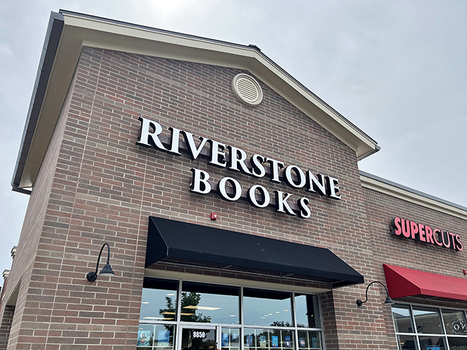 The brick fa&ccedil;ade of Riverstone Books stands like a literary lighthouse, beckoning bibliophiles with its simple, elegant signage against the blue Pittsburgh sky. 