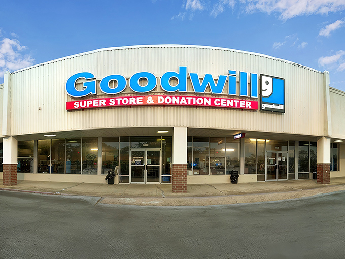 The curved facade of Goodwill's Super Store in Biloxi beckons like a blue-signed beacon of bargain possibilities, promising treasures waiting to be discovered inside.