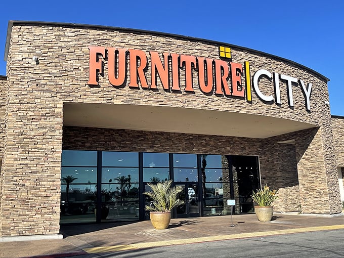 The grand entrance to Furniture City beckons with its impressive stone facade and bold signage—like the pearly gates of home decor heaven.