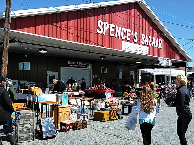The iconic red barn of Spence's Bazaar stands like a treasure chest waiting to be opened, promising adventures in bargain hunting under the Delaware sky.