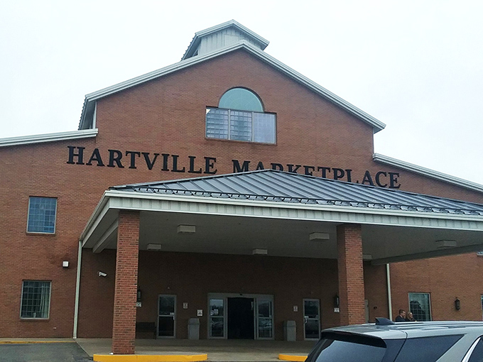 The brick facade of Hartville MarketPlace stands like a retail cathedral, promising treasures within. Even the parking lot buzzes with anticipation.