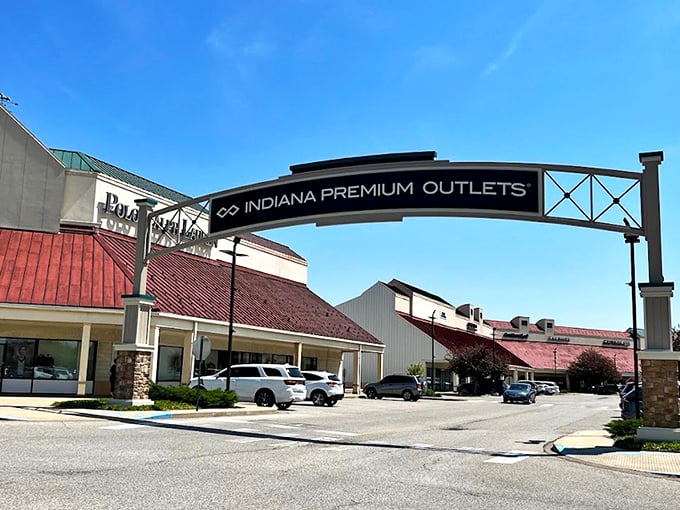 The iconic entrance arch to Indiana Premium Outlets welcomes bargain hunters like a retail Emerald City, promising treasures beyond the parking lot.