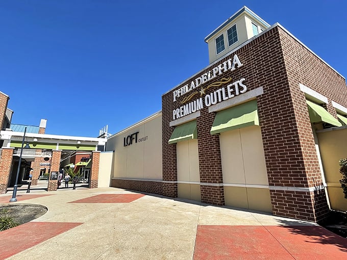 The brick facade of Philadelphia Premium Outlets welcomes bargain hunters like an old friend promising treasures within. LOFT beckons from just beyond the entrance.
