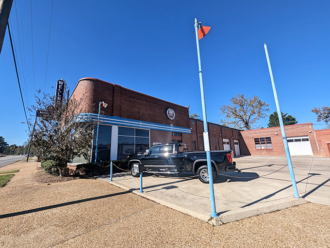 That vintage neon sign beckoning from the street promises automotive adventures that'll make your heart race faster than a Hemi.