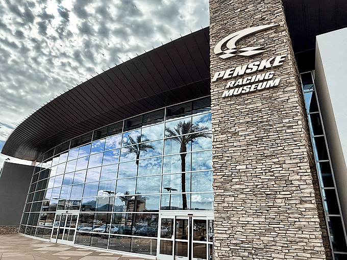 The sleek glass fa&ccedil;ade of Penske Racing Museum gleams in the Arizona sun, palm trees standing guard like pit crew members awaiting their champions.