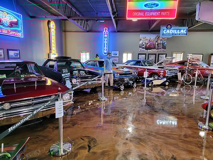 Step into automotive heaven where vintage storefronts and gleaming classics create a time-traveling wonderland. That blue convertible looks ready for a sunset cruise down memory lane.