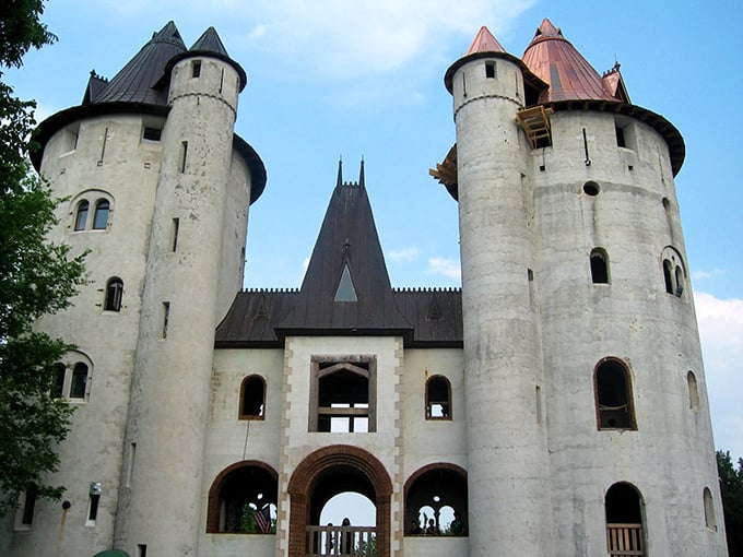 The majestic exterior of Castle Gwynn stands proudly against the Tennessee sky, its white towers a startling medieval vision in the Southern landscape.