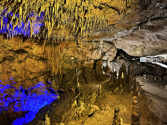 The cave's vibrant lighting transforms ancient limestone into nature's own psychedelic light show. Mother Nature's been decorating for millions of years, and it shows.