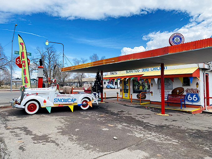 Route 66 nostalgia meets carnival funhouse at Delgadillo's Snow Cap, where even the vintage car out front refuses to take itself seriously.