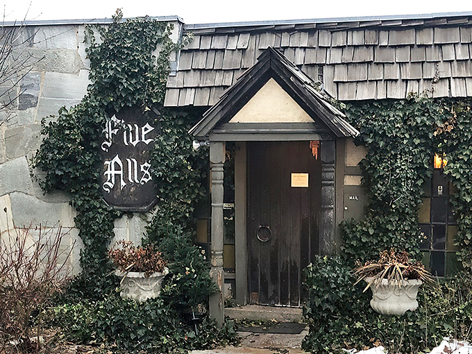 The entrance to Five Alls feels like a portal to medieval England, complete with ivy-covered walls and a door that practically begs you to say "Open sesame!"