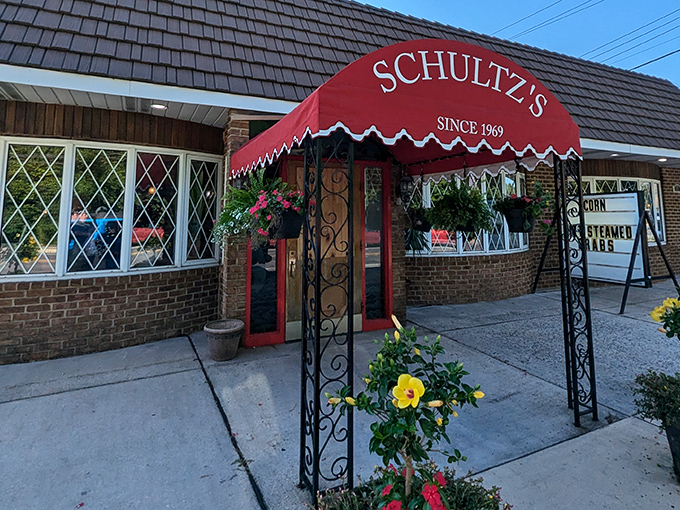 The iconic red awning of Schultz's welcomes you like an old friend, complete with cascading plants that seem to whisper, "You've arrived at somewhere special."