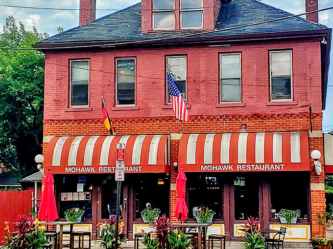 The iconic red and white striped awning of The Old Mohawk beckons like a culinary lighthouse in Columbus's charming German Village. Resistance is futile.