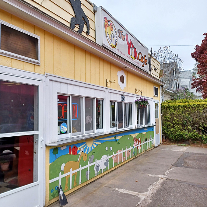 The sunshine-yellow exterior of The Yolk Cafe practically screams "happiness served here!" Those playful monkey silhouettes add a touch of whimsy to your breakfast adventure.