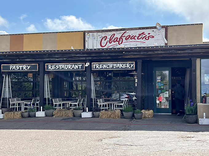 The unassuming exterior of Clafoutis beckons like a French postcard come to life, complete with charming patio seating perfect for people-watching with your pain au chocolat.
