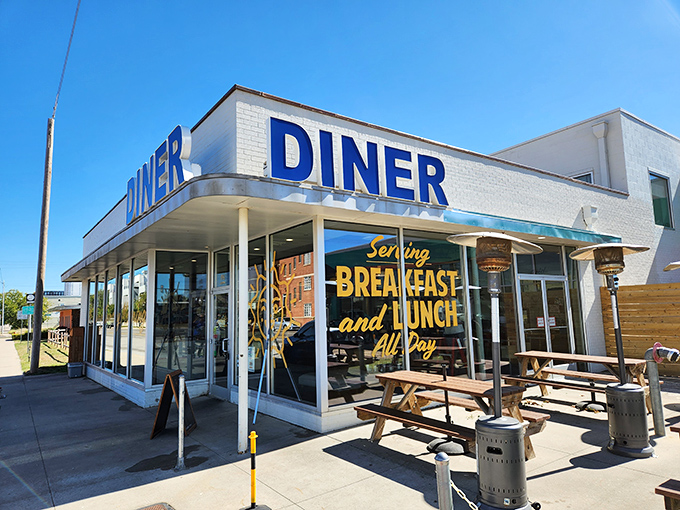 The iconic blue "DINER" sign beckons like a lighthouse for the breakfast-starved, promising all-day comfort in the heart of OKC.