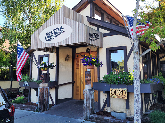 The entrance to breakfast paradise! Wooden bears stand guard at The Oak Table Cafe's doorway, promising a Pacific Northwest dining experience worth waking up for.