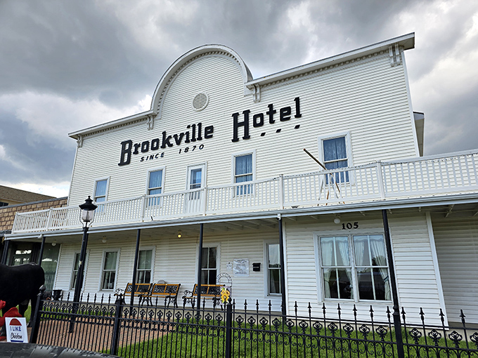 The iconic white facade of Brookville Hotel stands proudly against the Kansas sky, a beacon for fried chicken pilgrims from across the Midwest.
