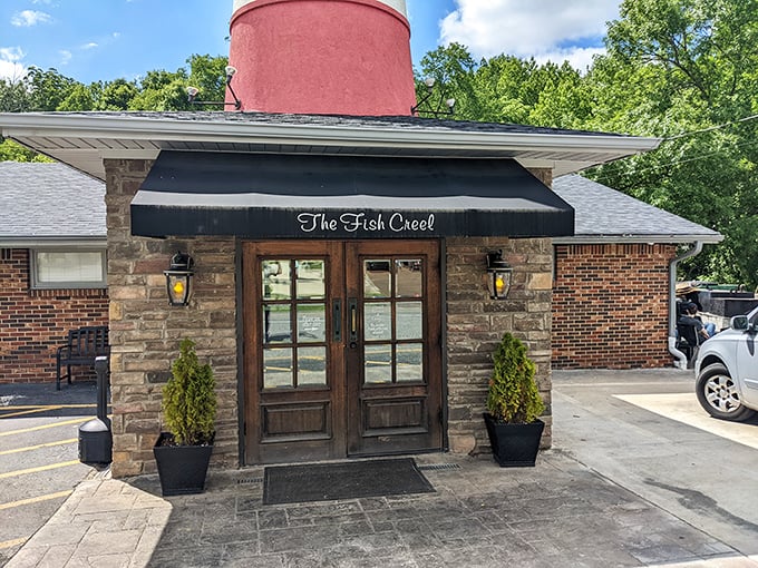 The lighthouse beckons! Fish Creel's iconic red and white tower stands as a quirky landmark, promising seafood treasures in landlocked northern Alabama.