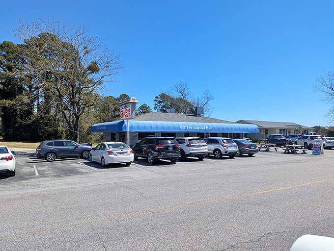 The iconic blue awning of The Seafood Hut stands as a beacon for seafood lovers, promising Calabash-style delights within those humble walls.
